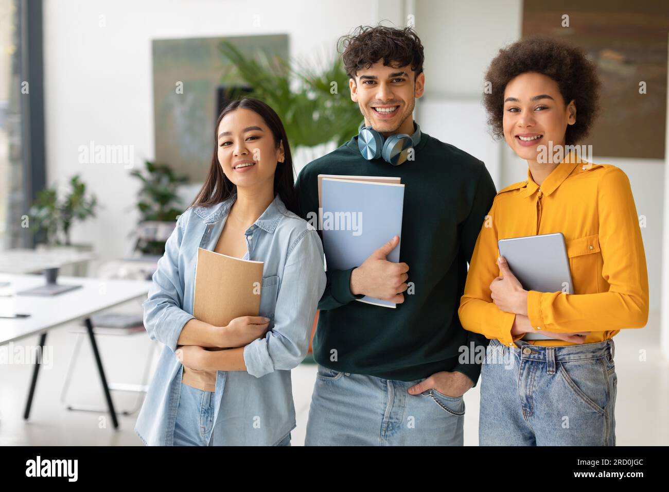 Happy three multiracial students posing in coworking space, young ...