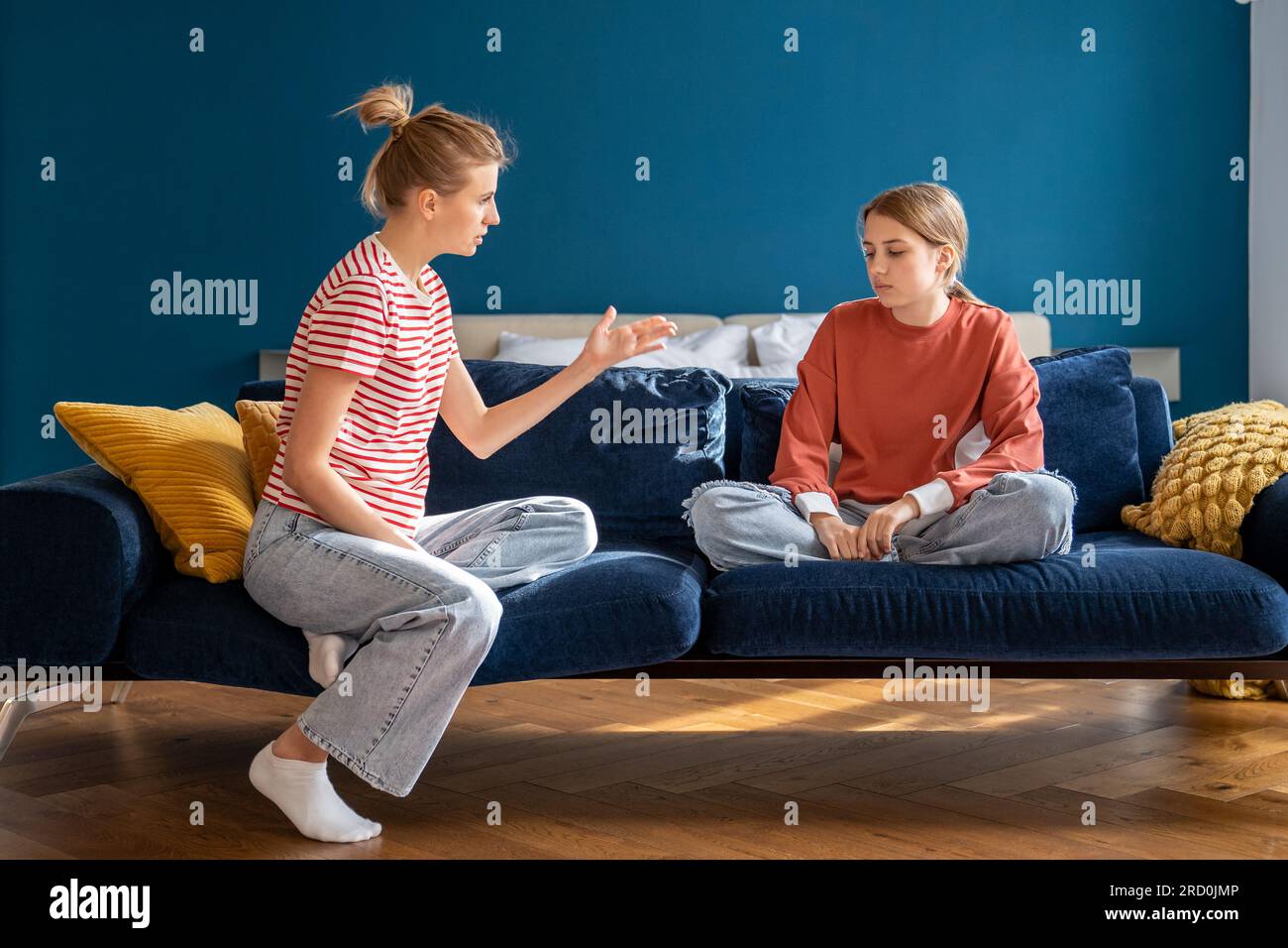 Irritated mother sit on couch talk to bored ignoring teenager at home ...