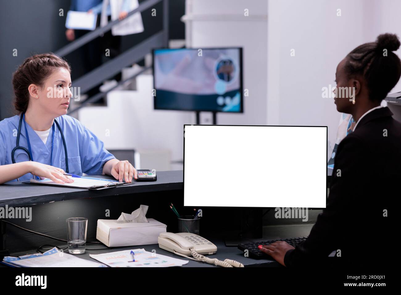African american receptionist using pc with white isolated screen at ... African american receptionist using pc with white isolated screen at ...