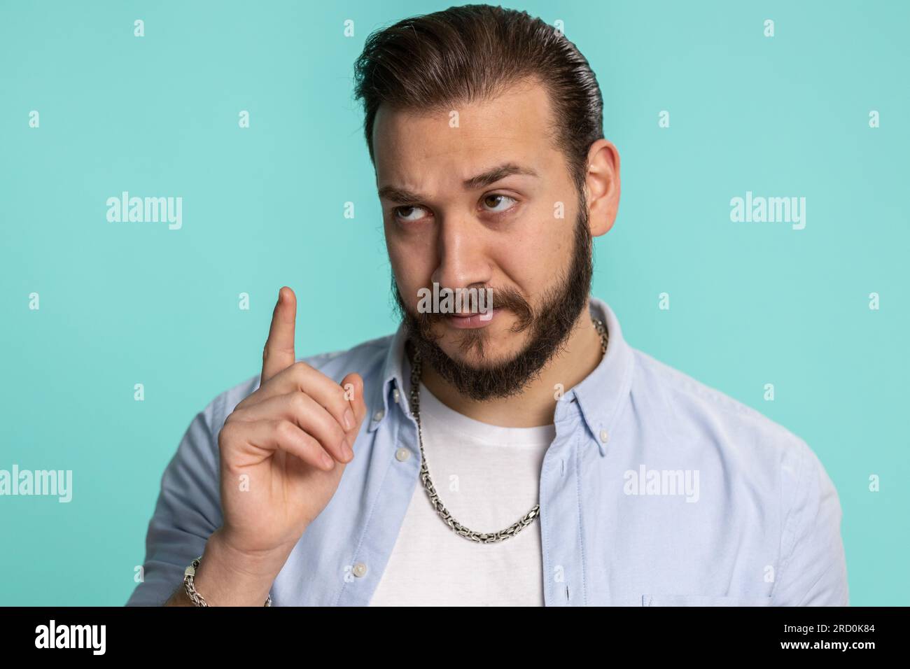 Eureka. Inspired young lebanese man pointing finger up with open mouth ...