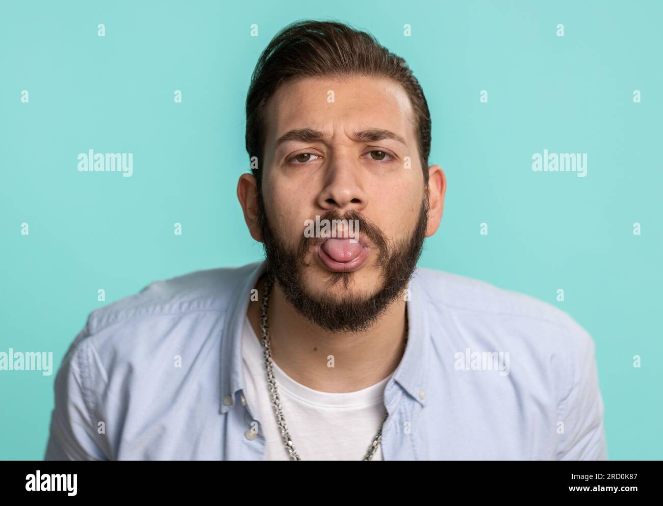 Comical funny young lebanese man making playful silly facial ...