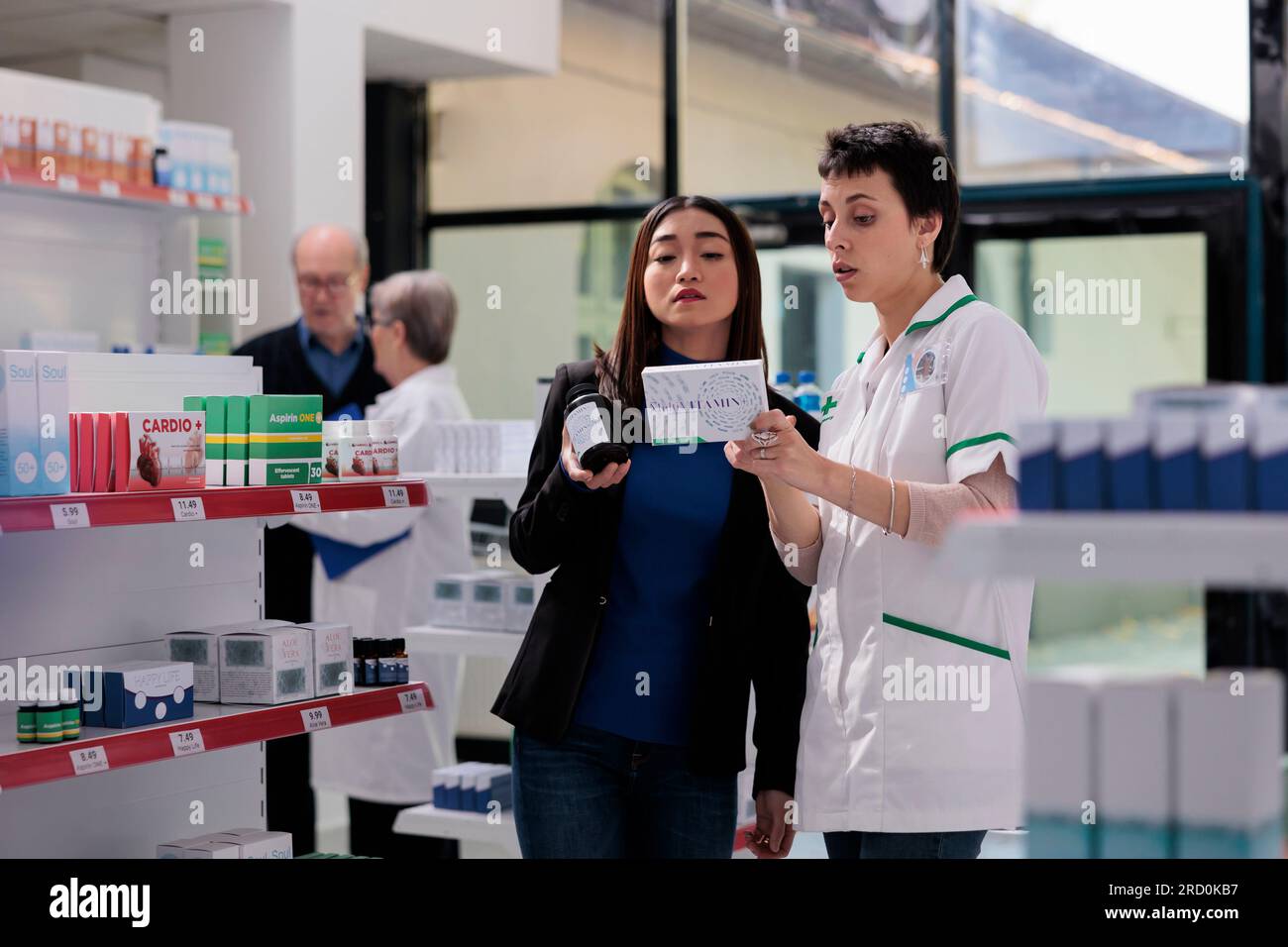 Pharmacist and medical store customer comparing vitamin boxes and ...