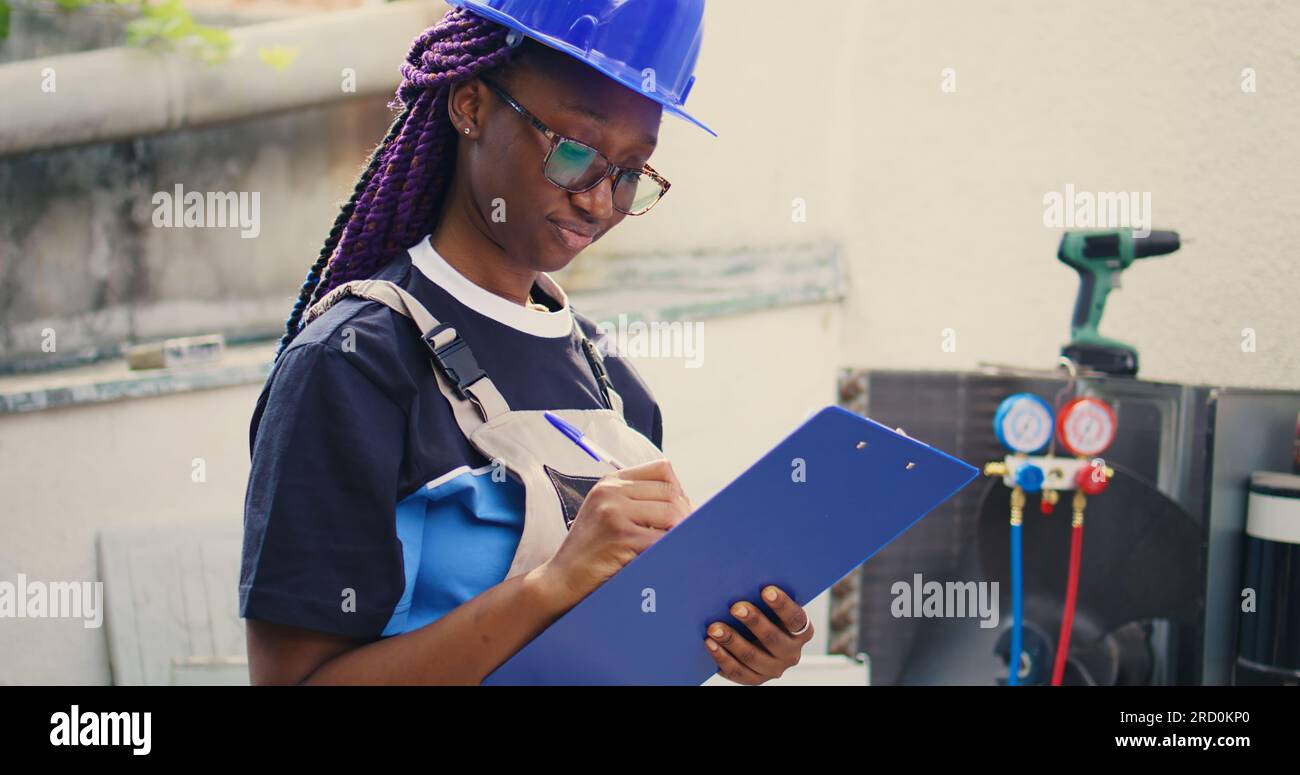 Portrait shot of smiling african american expert doing inspection of ...
