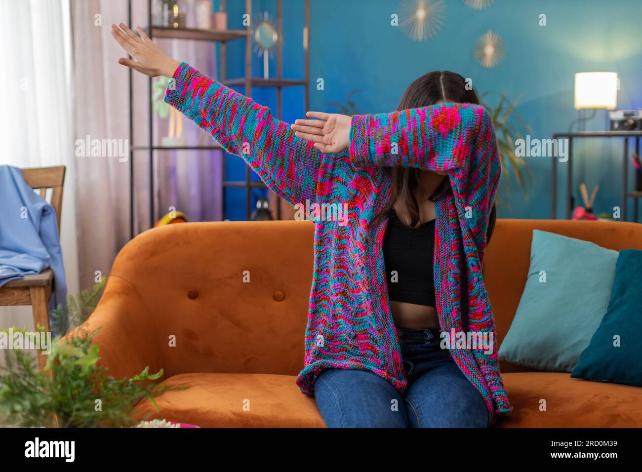 Trendy cheerful positive young woman having fun dancing and moving to ...