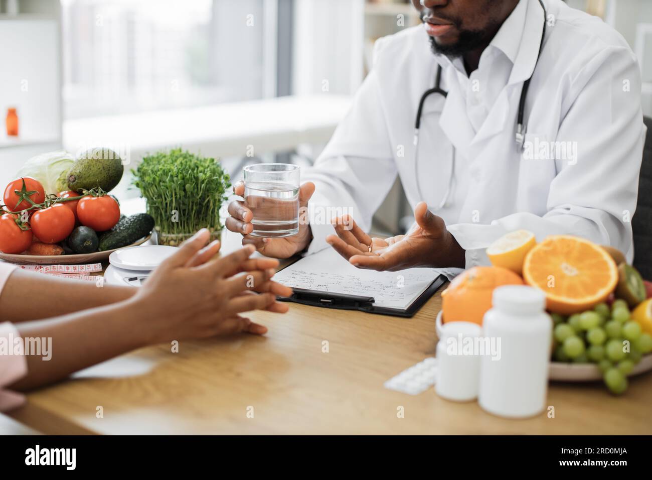 Cropped view of multiracial people discussing benefits of water while ...