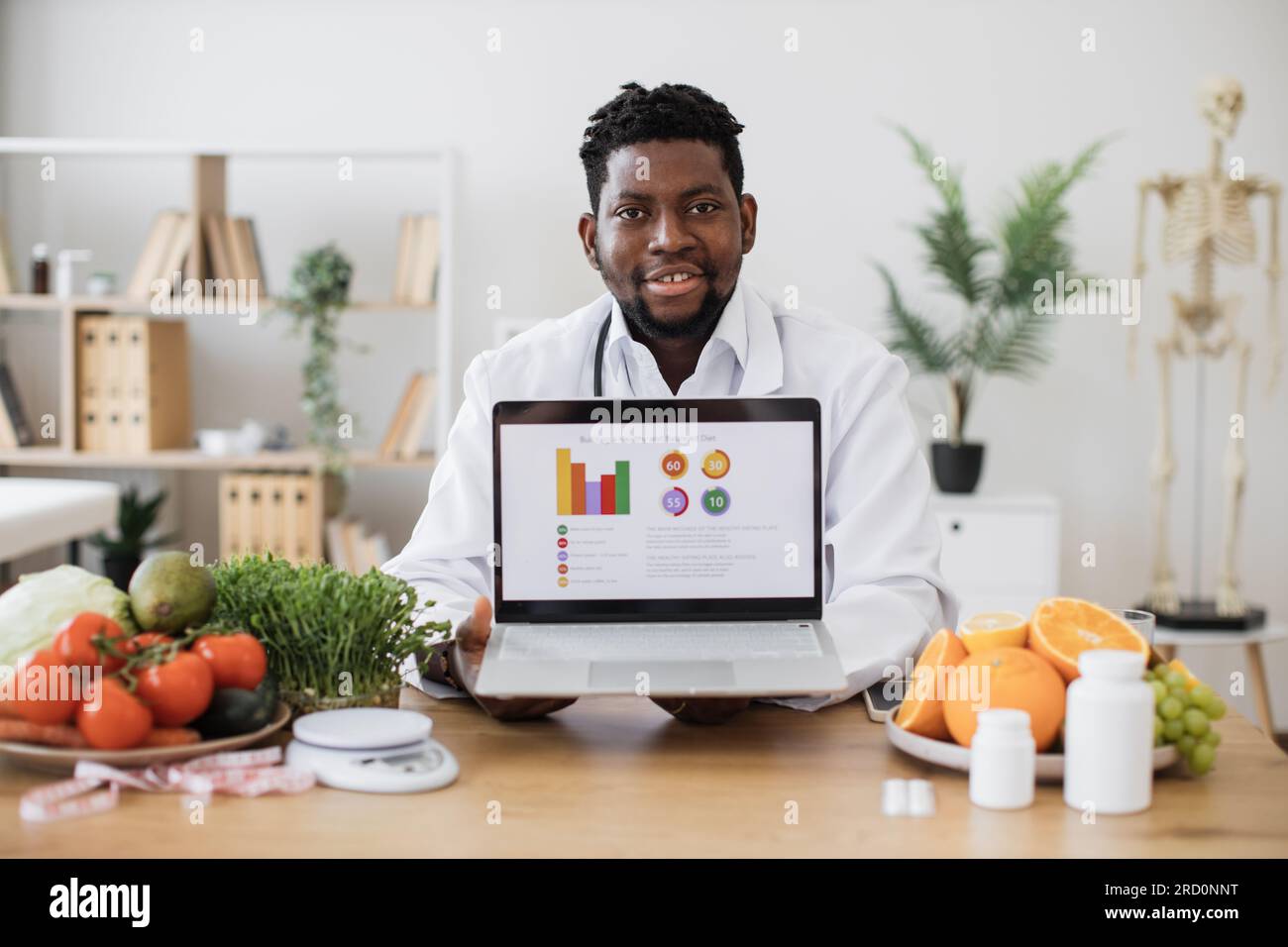 Portrait of skilled nutrition specialist sitting at desk with remote ...