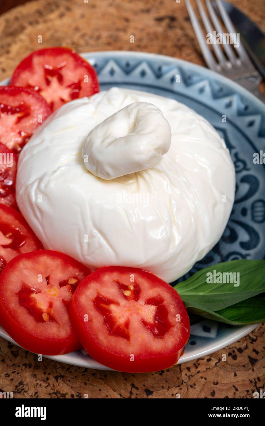 Fresh handmade soft Italian cheese from Puglia, white ball of burrata ...