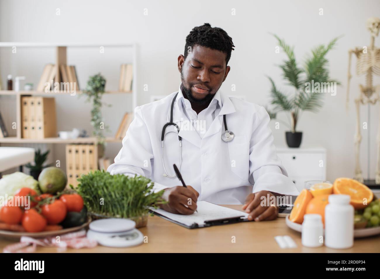 Doctor gastroenterologist filling patient's case history and ...