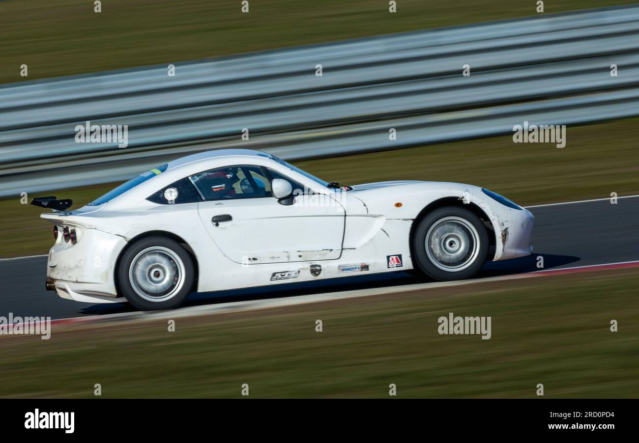 Panning photograph of sports racing car on Snetterton track Stock Photo ...