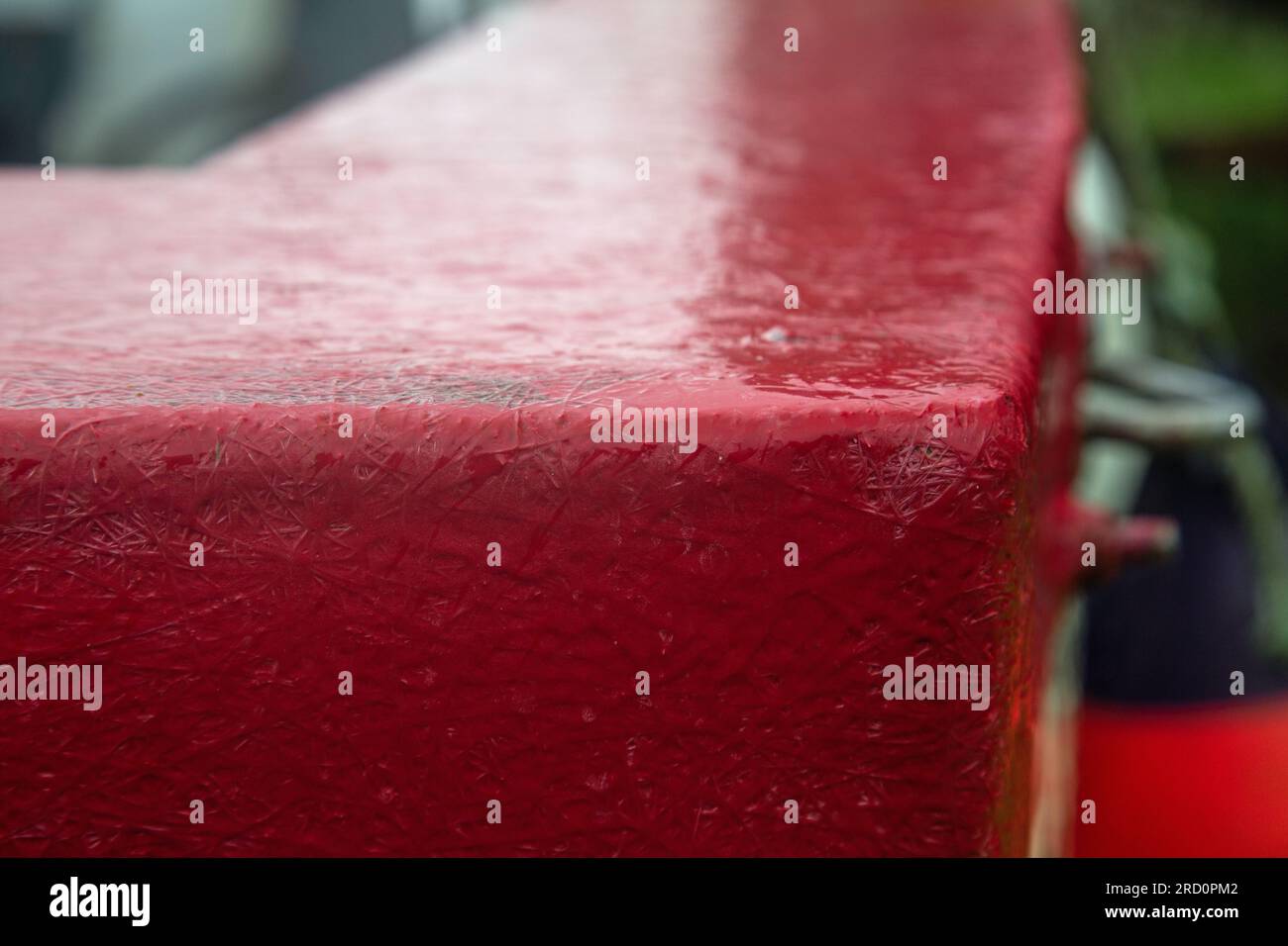 RED PAINTED FIBREGLASS CORNER ON A BOAT SHOT CLOSE UP Stock Photo - Alamy