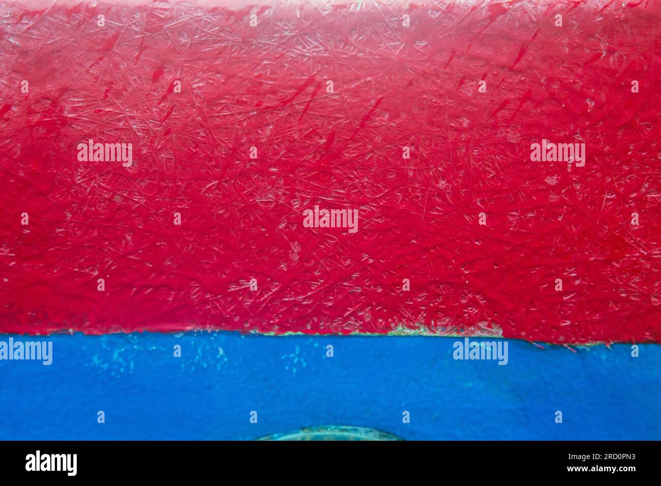 Painted red and blue fibreglass panel shot close up for use as a ...