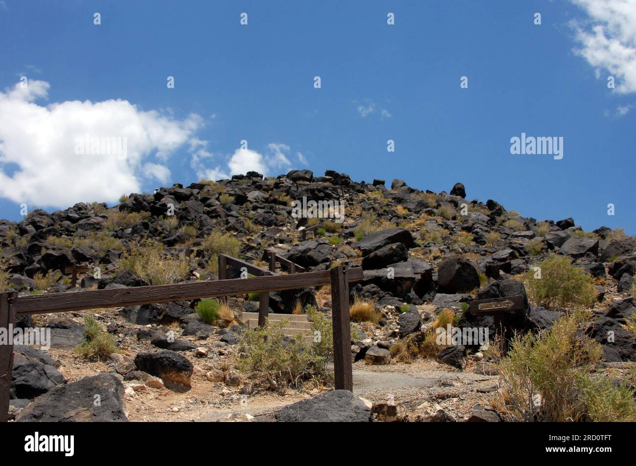 Rustic wooden rails line the trail ascending to the top of the mesa ...