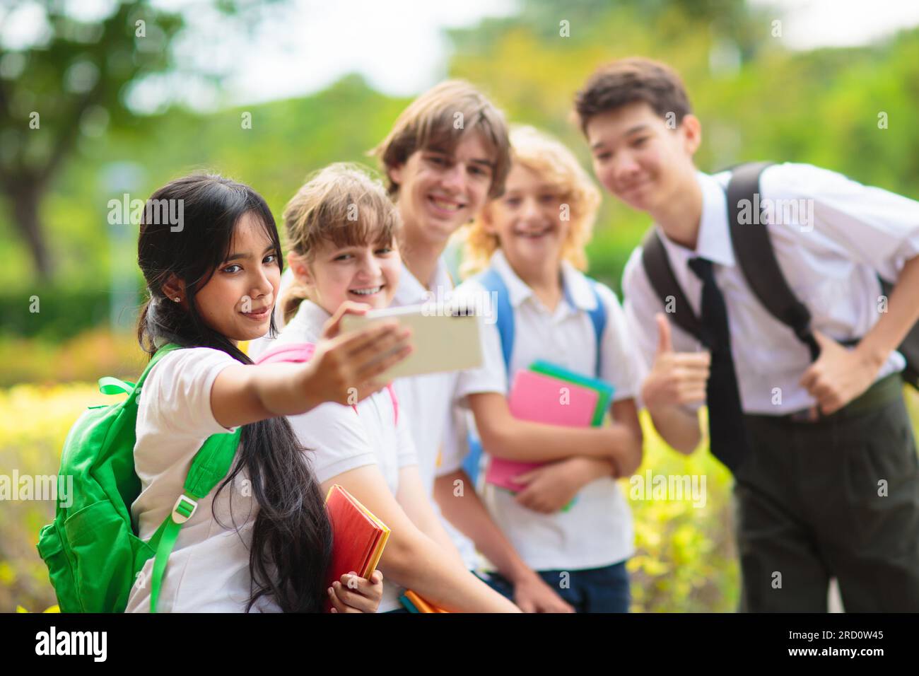 Kids go back to school. Interracial group of children take selfie with ...