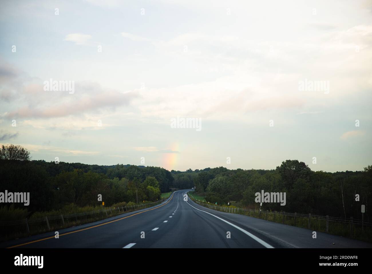 A landscape scenery with a lakefront property surrounded by forests ...