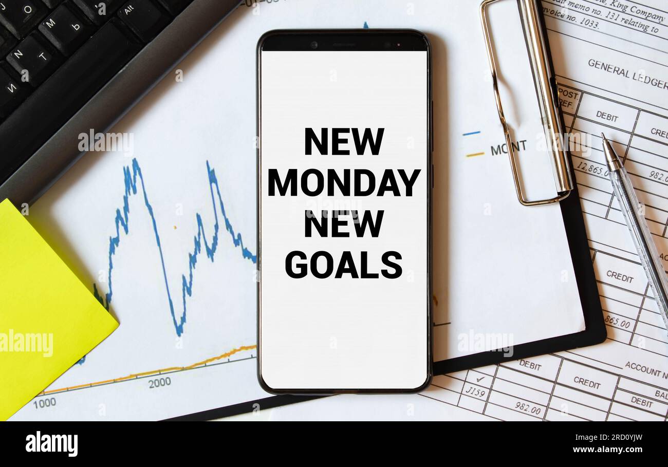 New Monday New Week New Goals written on green note on a orange ...
