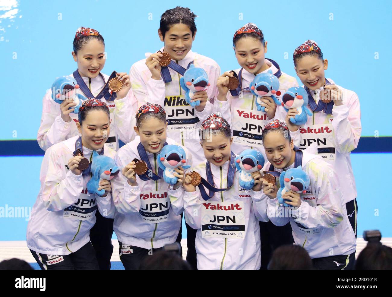 Japanese team poses with their bronze medals after competing in the ...