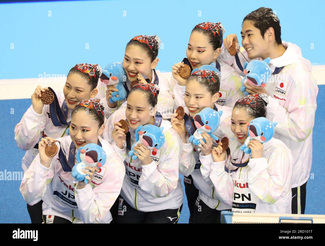 Japanese team poses with their bronze medals after competing in the ...