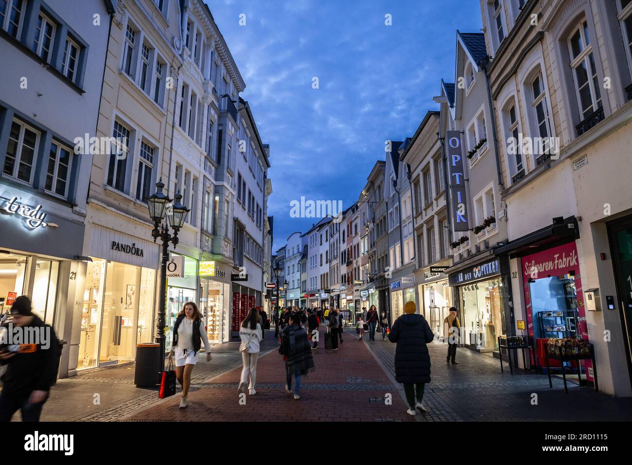 Picture of facades of a medieval street at dusk, with shops and ...