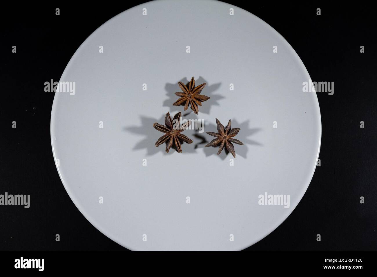 Picture of a star anise on a black background. Anise, also called ...