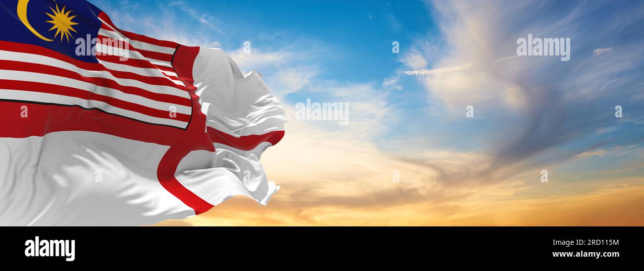 official flag of Naval Ensign 1963 1968 Malaysia at cloudy sky background on sunset, panoramic ...