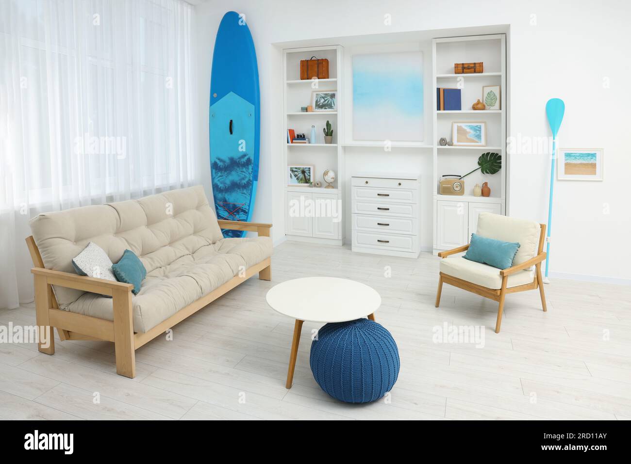 SUP board and modern furniture in stylish living room. Interior design ...