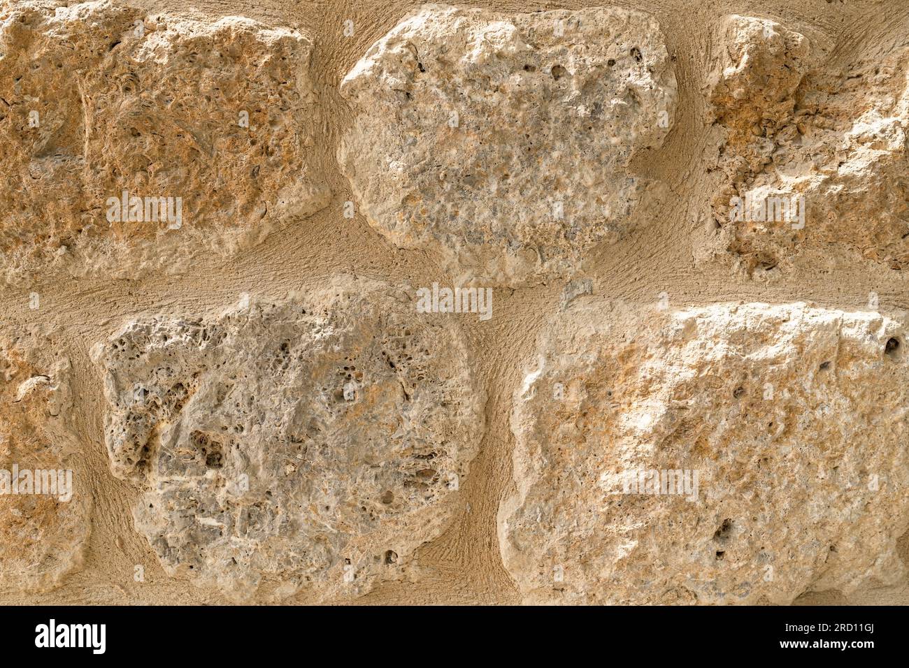 Old beige stone wall background texture close up. Castle wall surface ...
