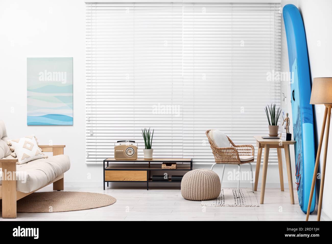 SUP board, workplace and sofa in room. Interior design Stock Photo - Alamy