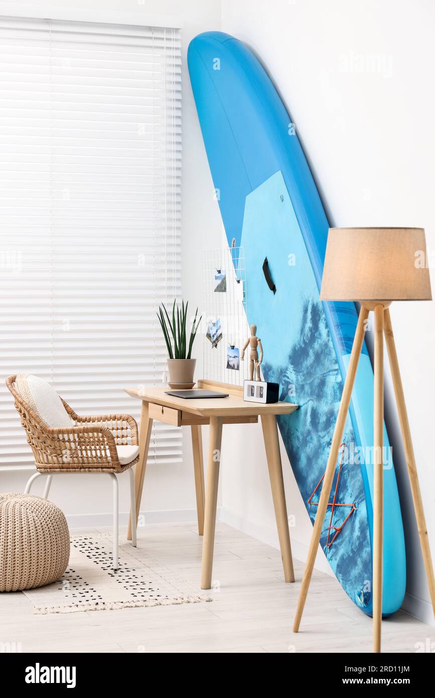 SUP board and workplace in room. Interior design Stock Photo - Alamy