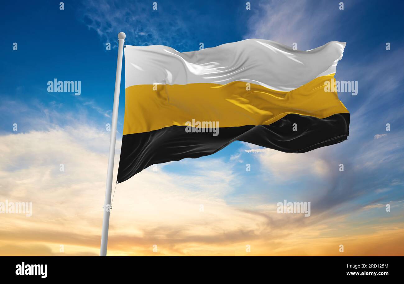 official flag of Perak Malaysia at cloudy sky background on sunset ...