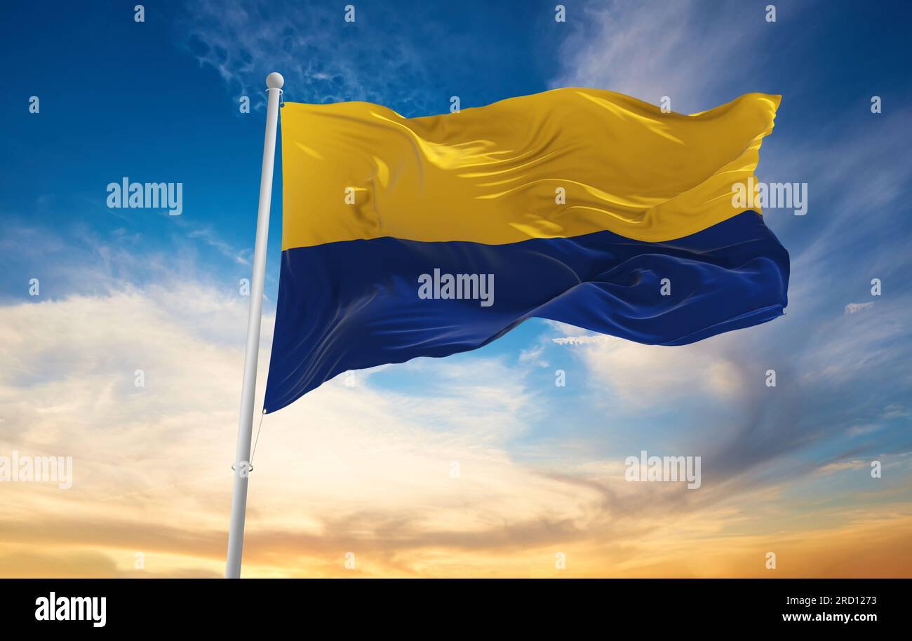 official flag of Perlis Malaysia at cloudy sky background on sunset ...