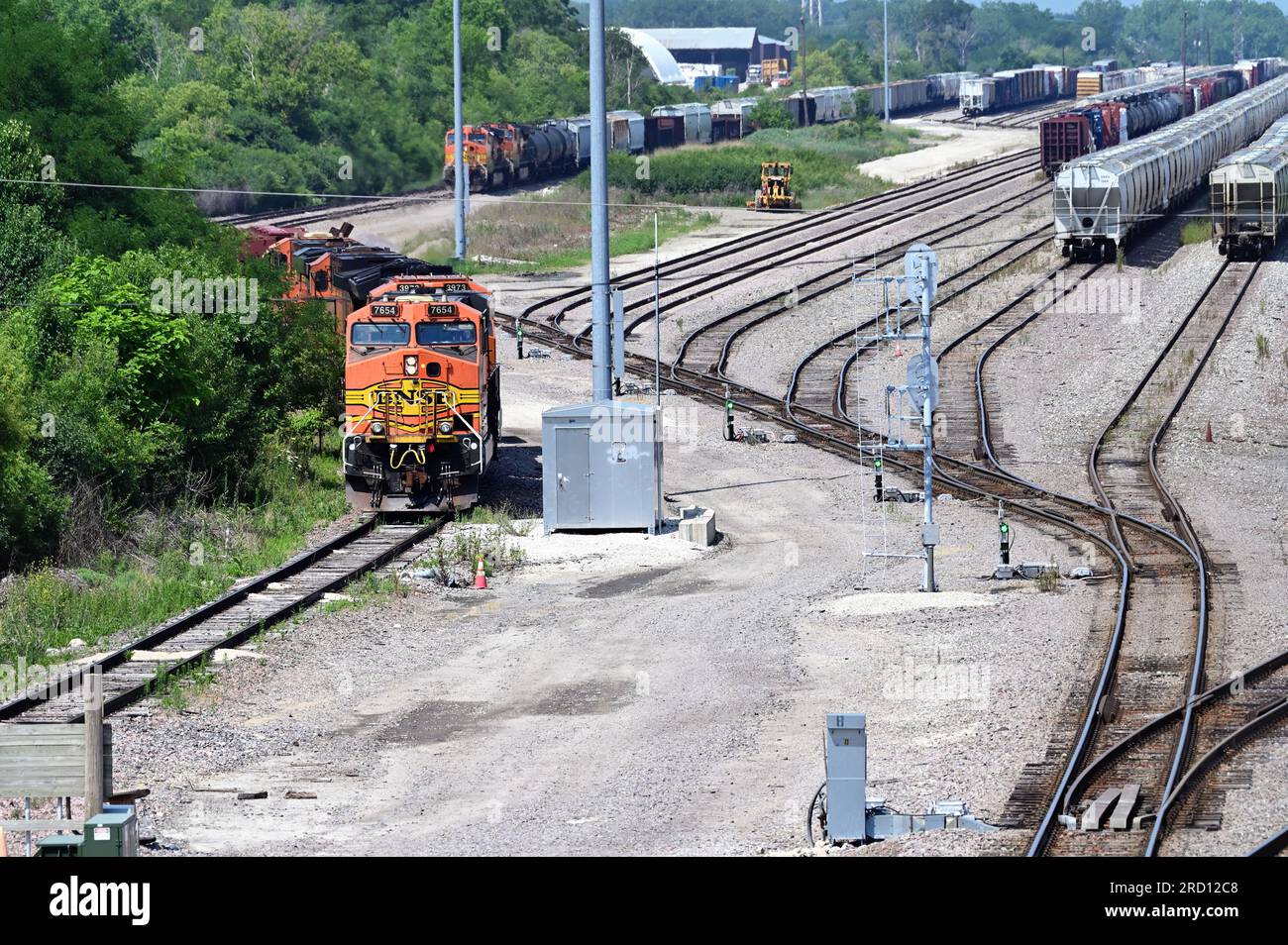 Aurora, Illinois, USA. Burlington Northern Santa Fe locomotives exiting a railroad freight yard ...