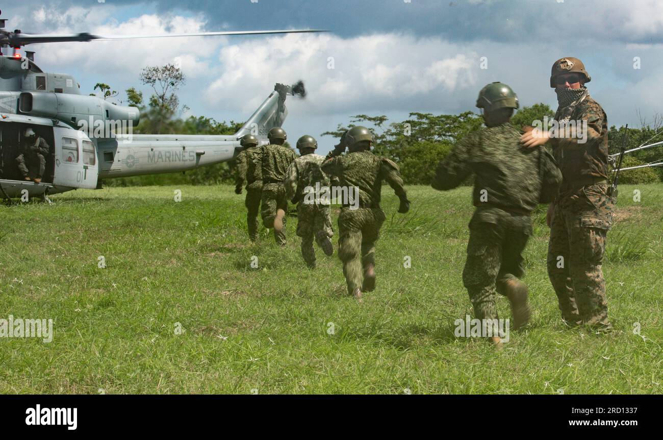Colombian marines and members of partner nations run to a UH-1Y Venom ...