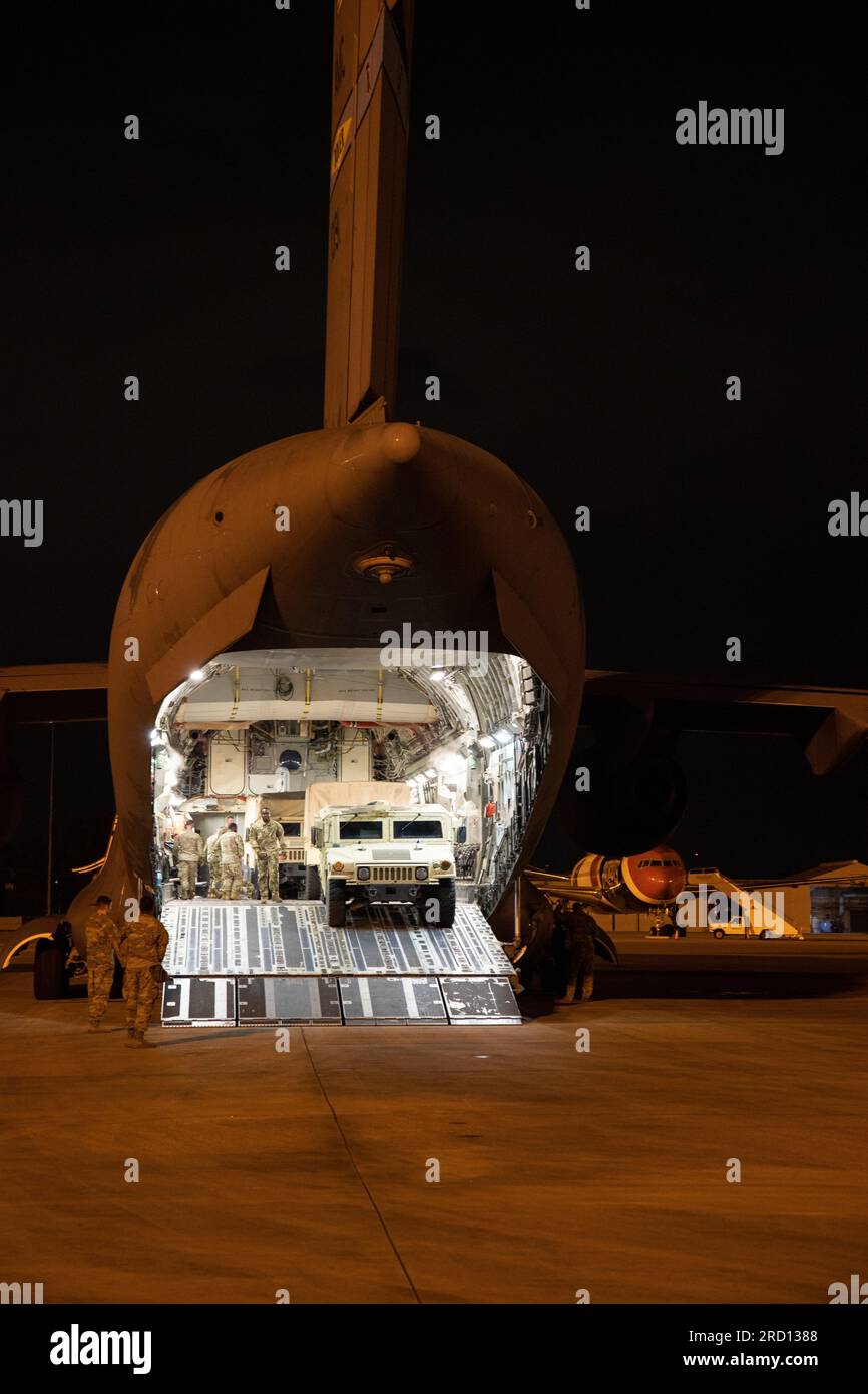 Soldiers load equipment onto a C-17 Globemaster III with support from U.S. Air Force Air ...