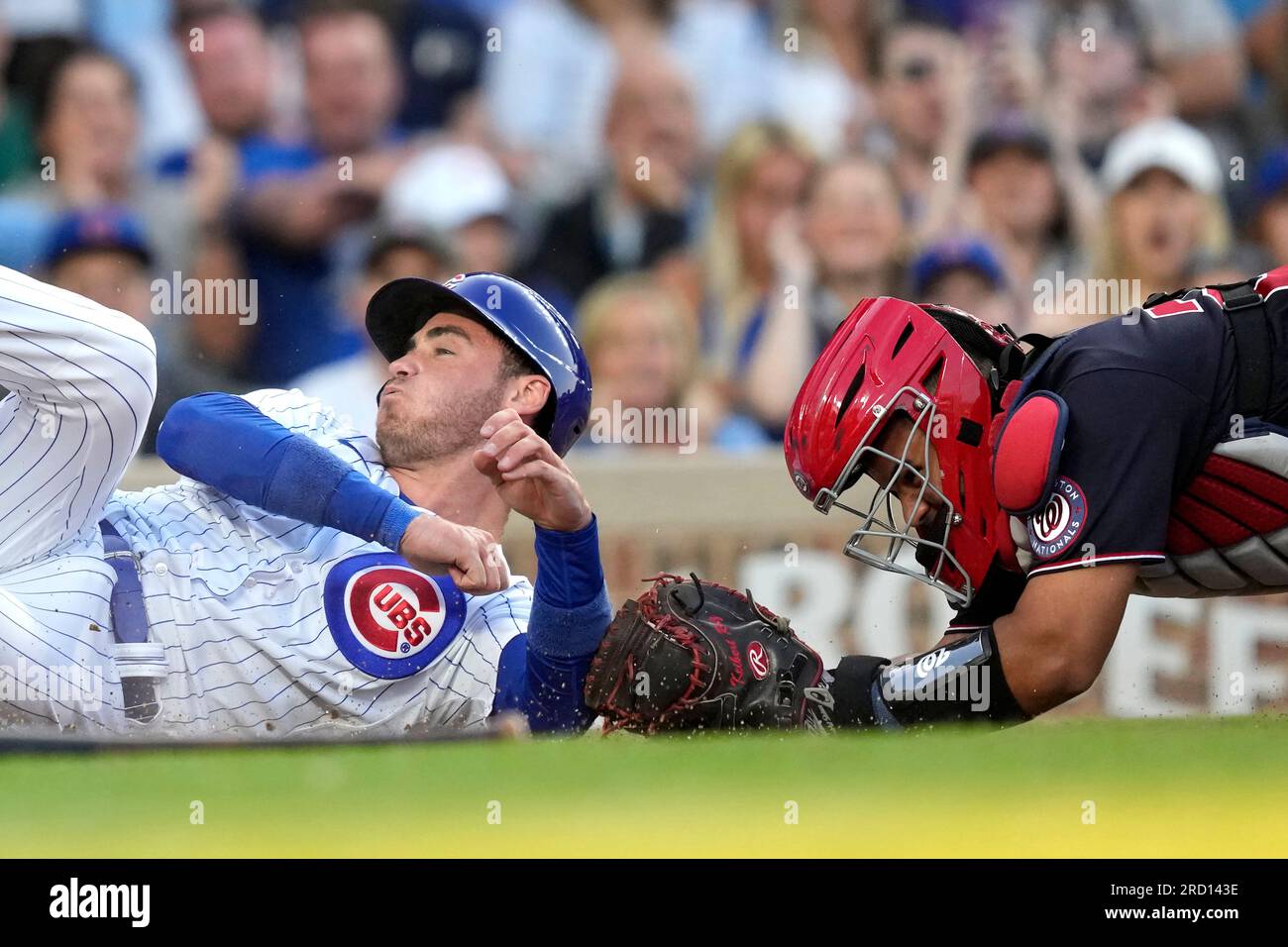 Chicago Cubs' Cody Bellinger, left, scores past Washington Nationals ...