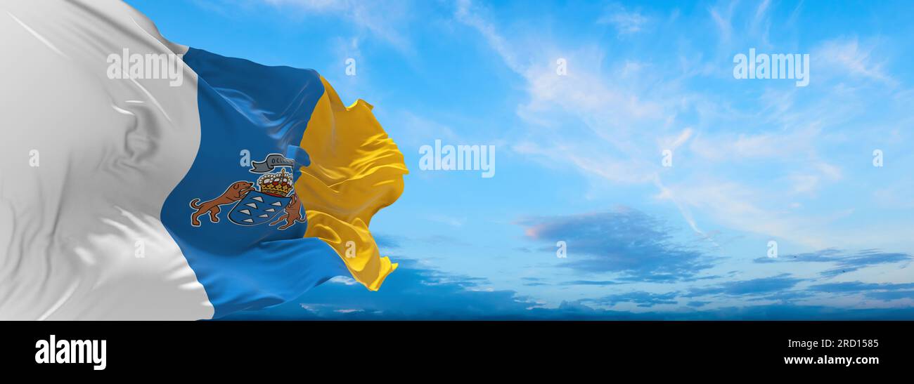 flag of Ibero-Romance peoples Canarians at cloudy sky background ...