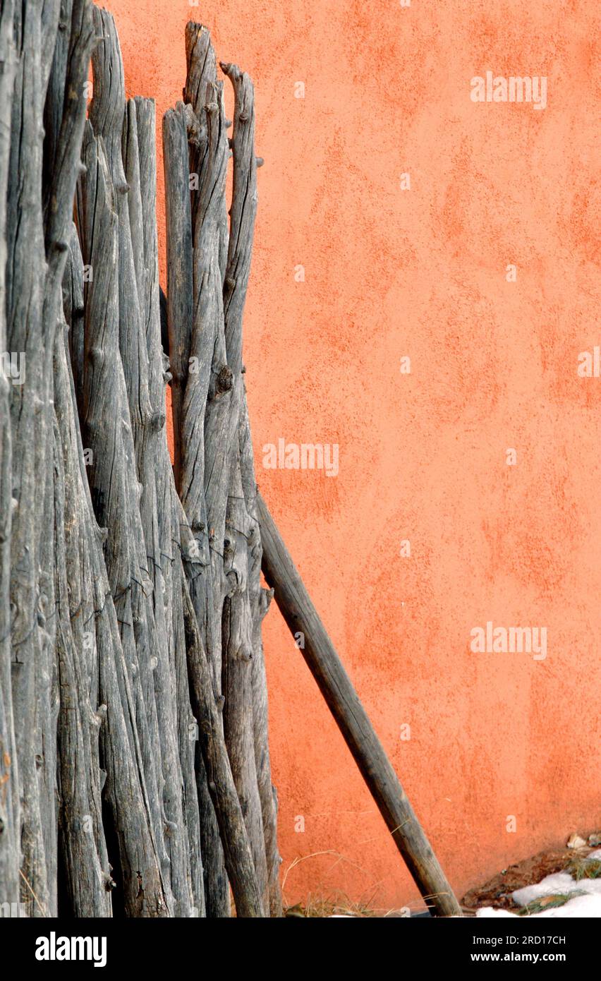 Background image of a stucco wall with rustic wooden fence besides it ...