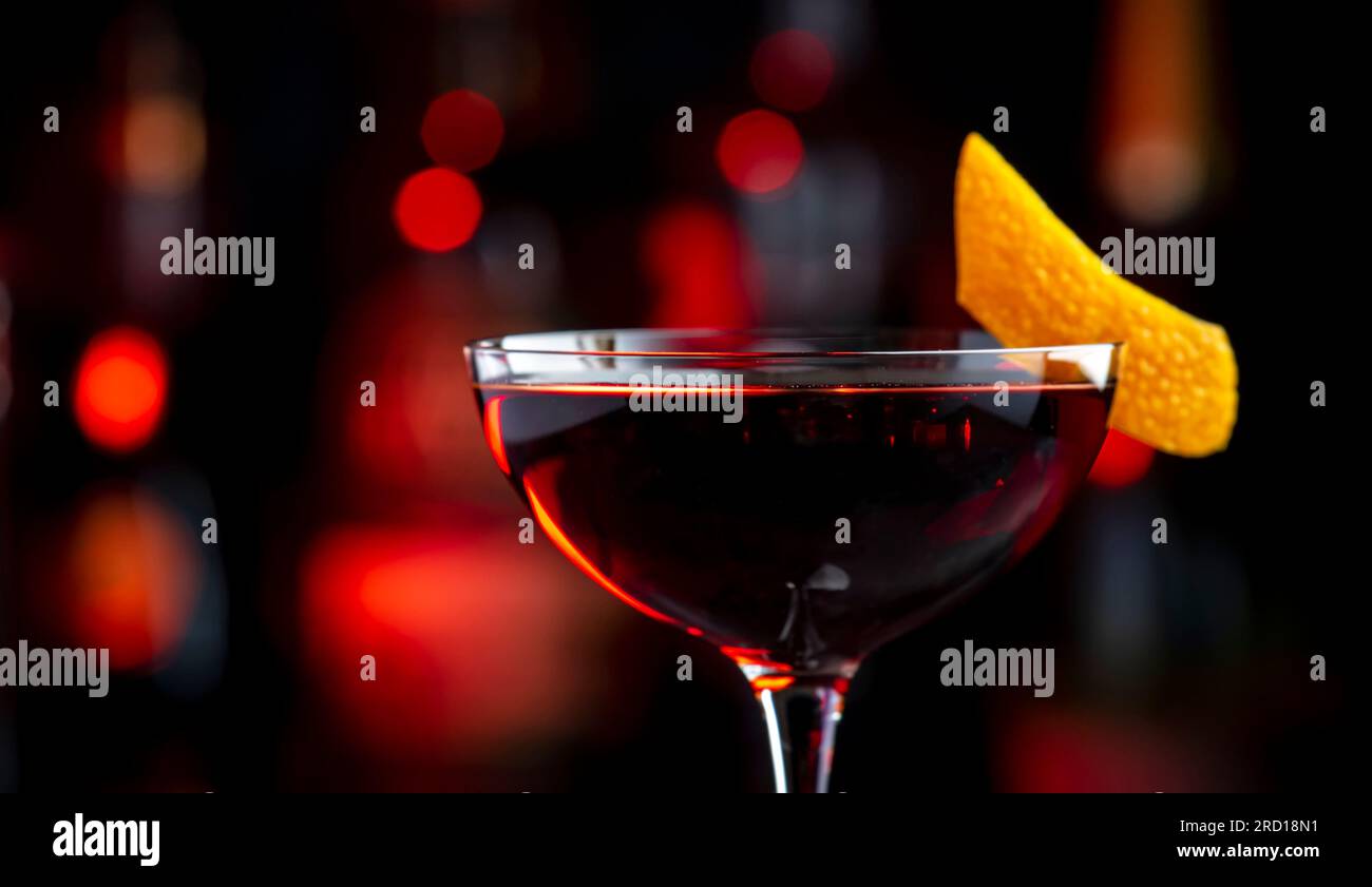 Adonis alcoholic cocktail drink with sherry and red vermouth, black bar ...