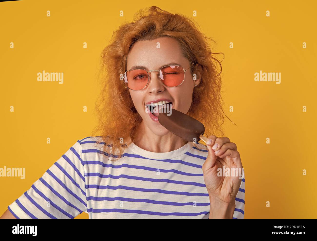 girl eating icelolly ice cream on background. photo of girl with ...