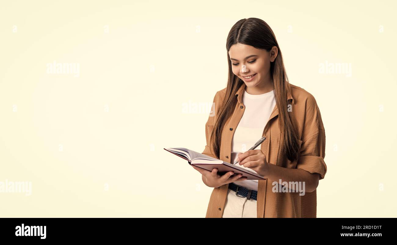 teen girl noting school diary book, copy space. photo of teen girl ...