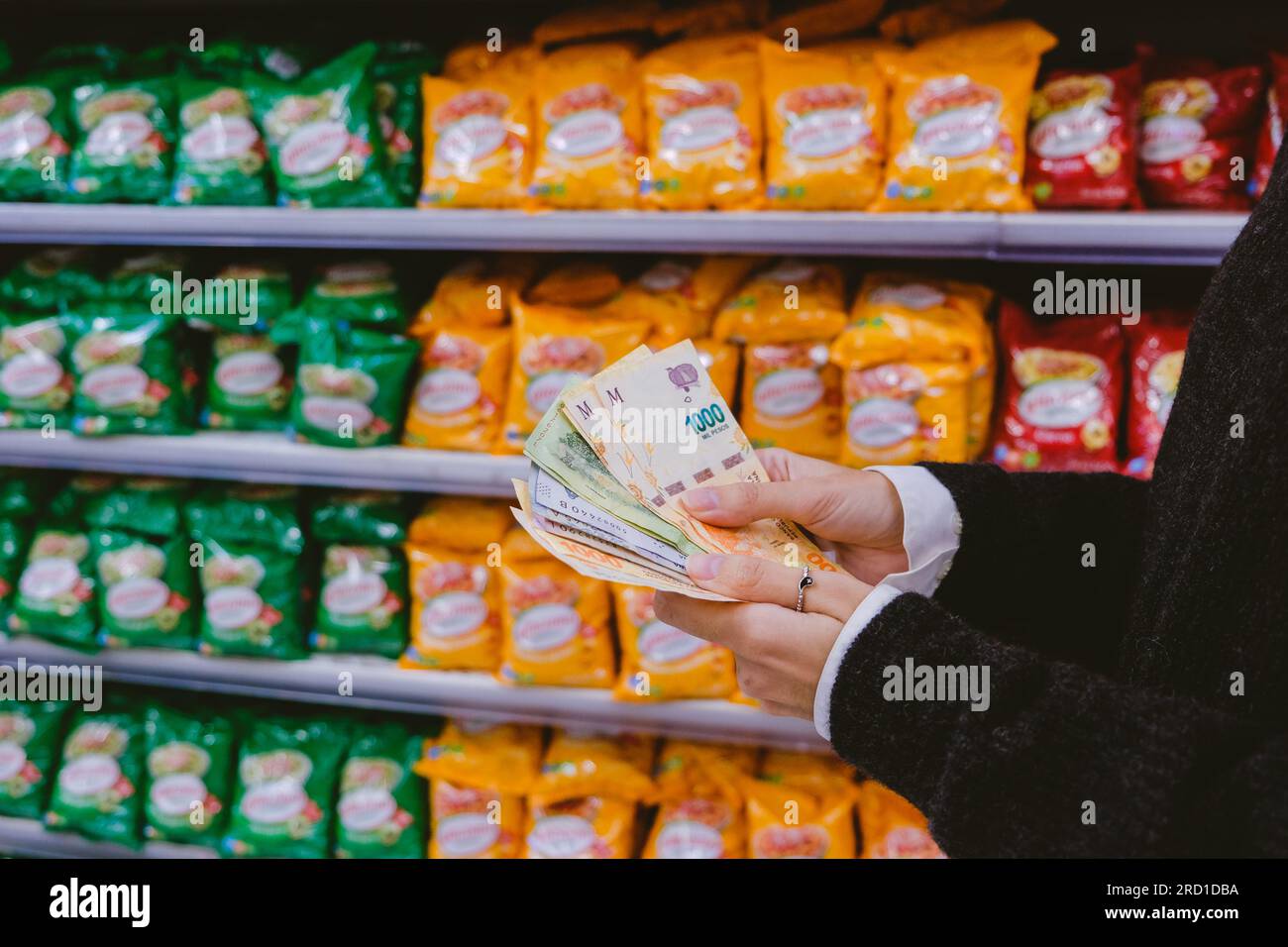 Woman counting money -Argentine pesos- in the supermarket Stock Photo ...