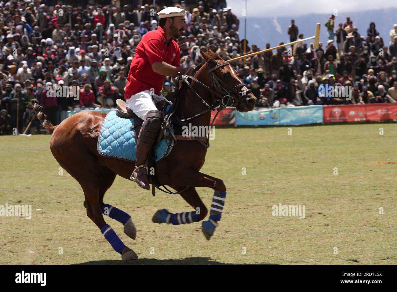 Polo players galloping on their horses during the game at the Shandur ...