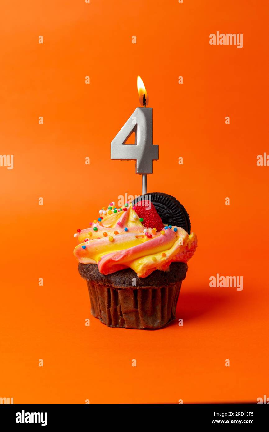 birthday cake with number 4 - cupcake on orange background with ...