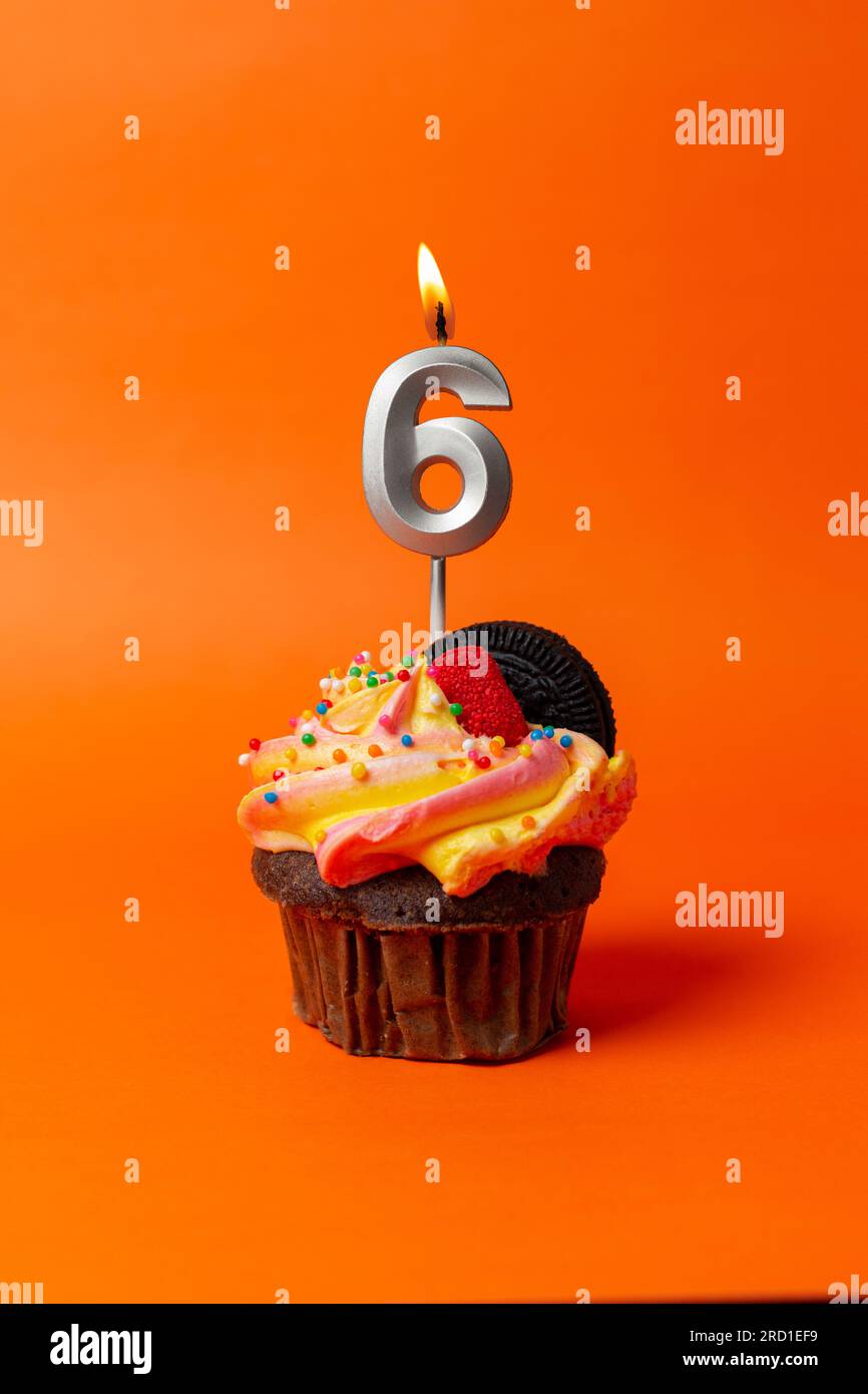 birthday cake with number 6 - cupcake on orange background with ...