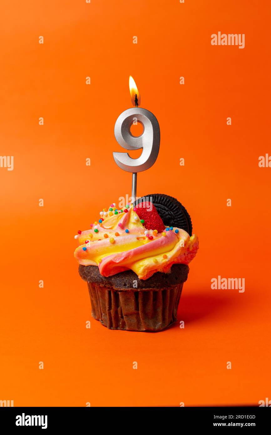 birthday cake with number 9 - cupcake on orange background with ...