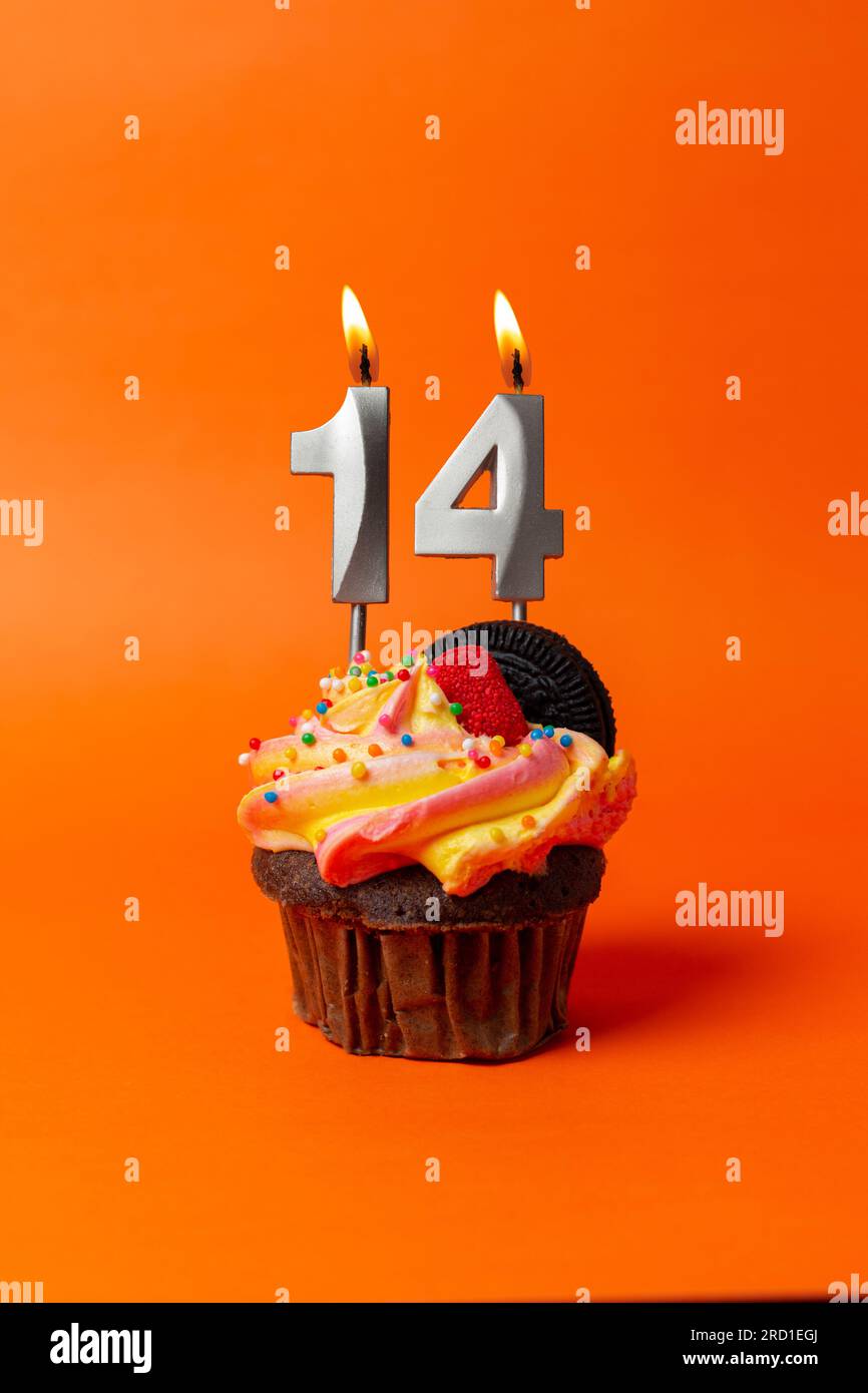 birthday cake with number 14 - cupcake on orange background with ...