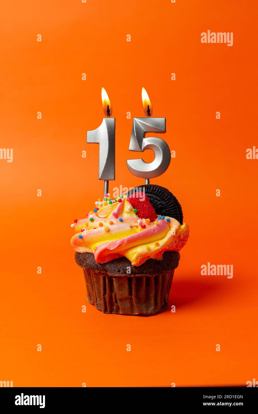 birthday cake with number 15 - cupcake on orange background with ...