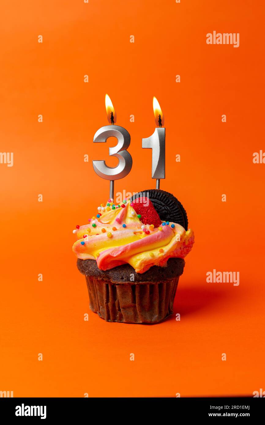 birthday cake with number 31 - cupcake on orange background with ...