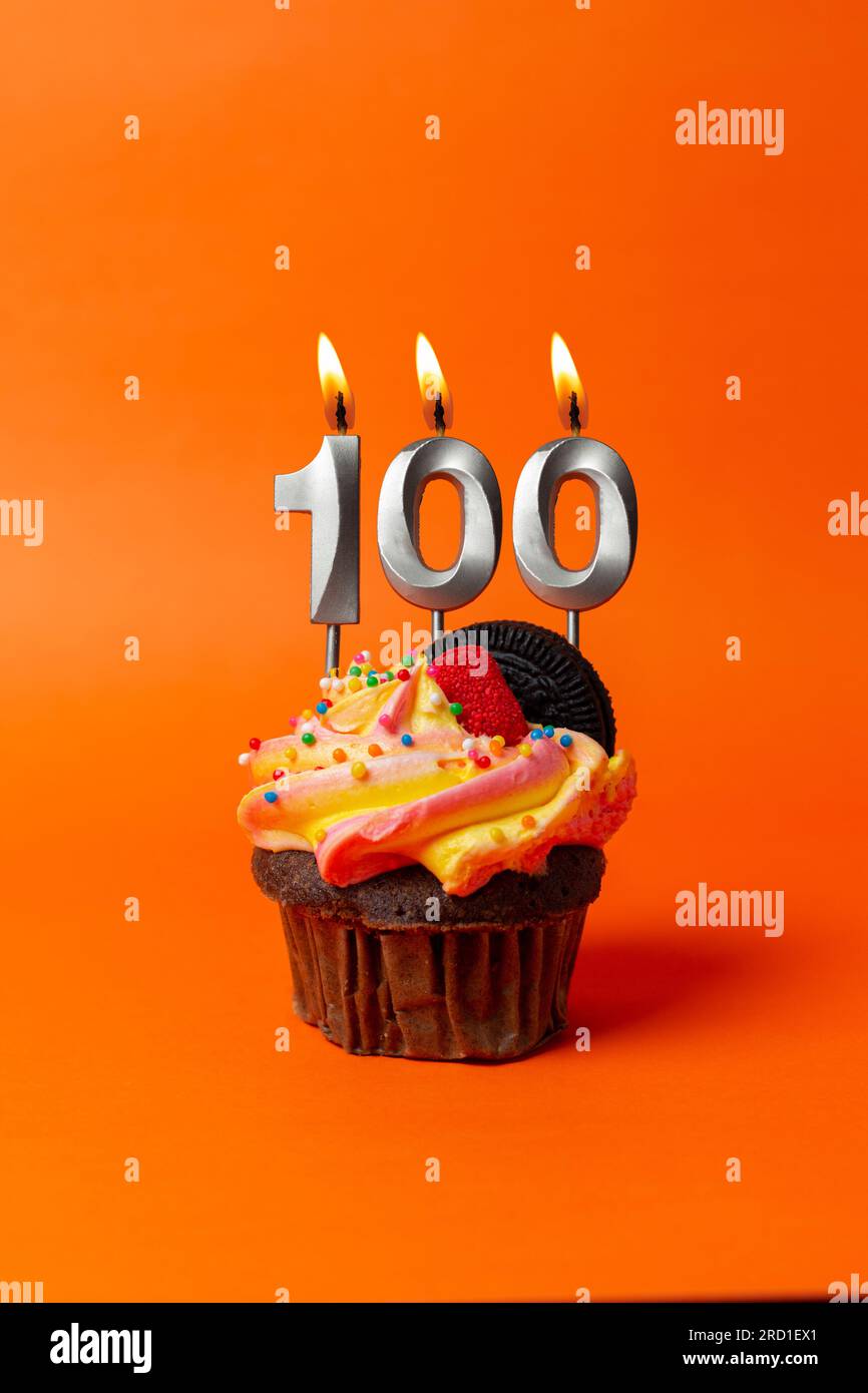birthday cake with number 100 - cupcake on orange background with ...