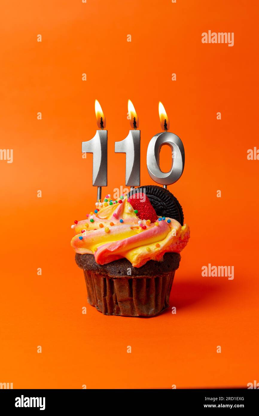 birthday cake with number 110 - cupcake on orange background with ...
