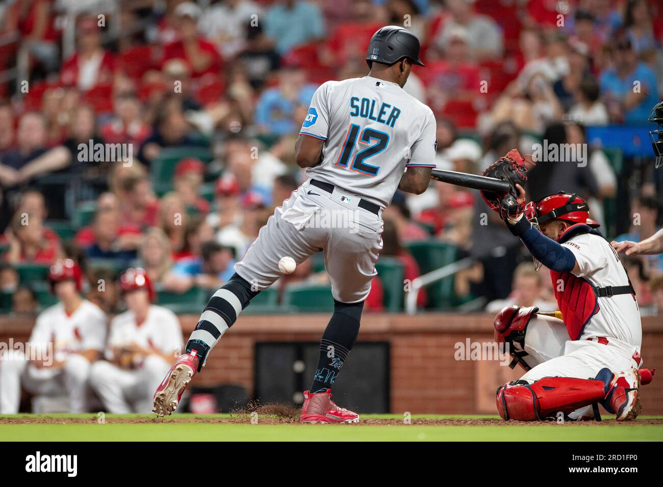 Miami Marlins designated hitter Jorge Soler (12) reacts after being hit ...